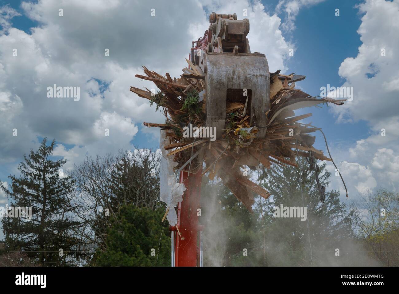 Dismantling an old house, bulldozer destroys of the demolition of a ...