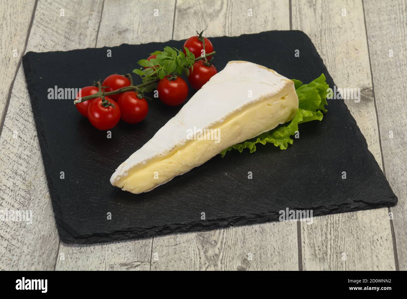 Brie cheese triangle served salad leaves Stock Photo - Alamy