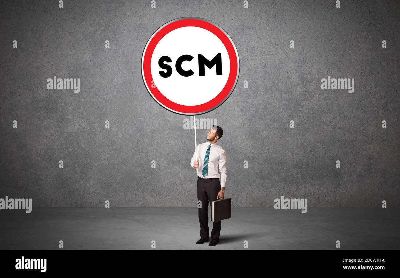 Young business person holdig traffic sign with SCM abbreviation ...