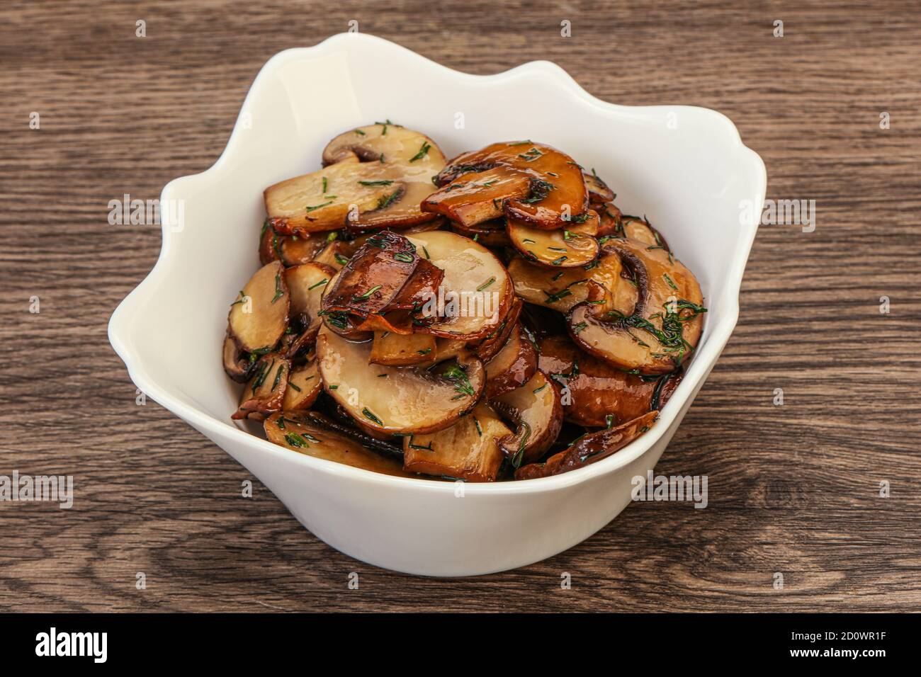 Roasted champignon with herbs and spices in the bowl Stock Photo - Alamy