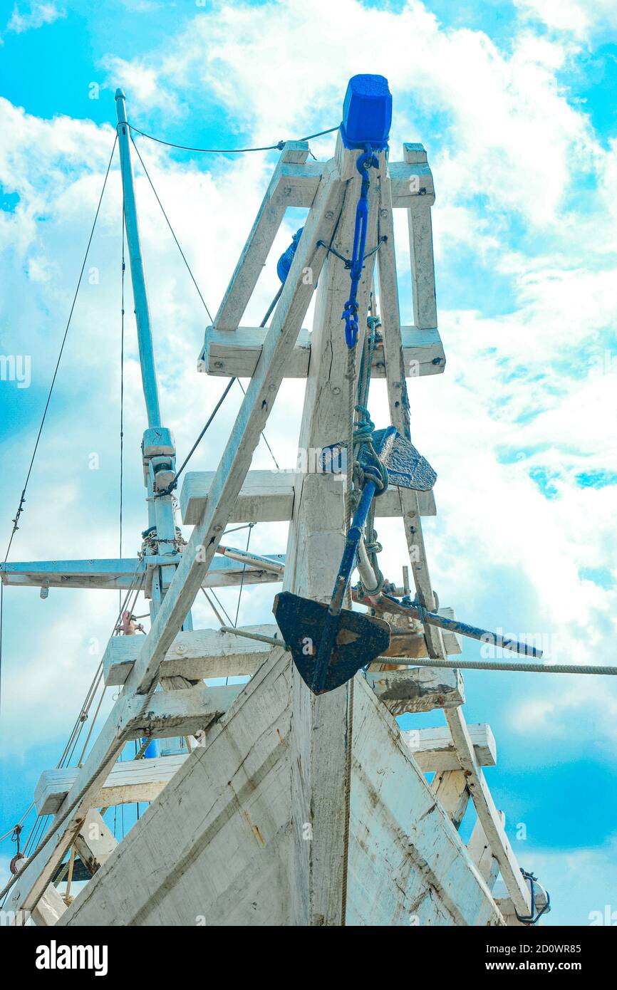 Vertical shot of the front of a ship under the blue sky and white ...