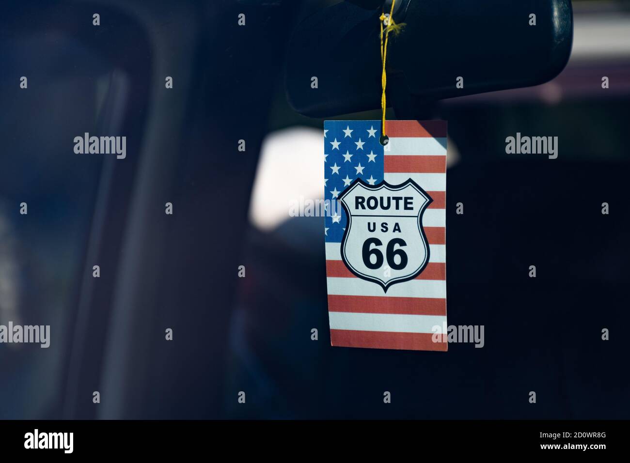 Route 66 symbol or logo hanging on the rear-view mirror in a car with ...
