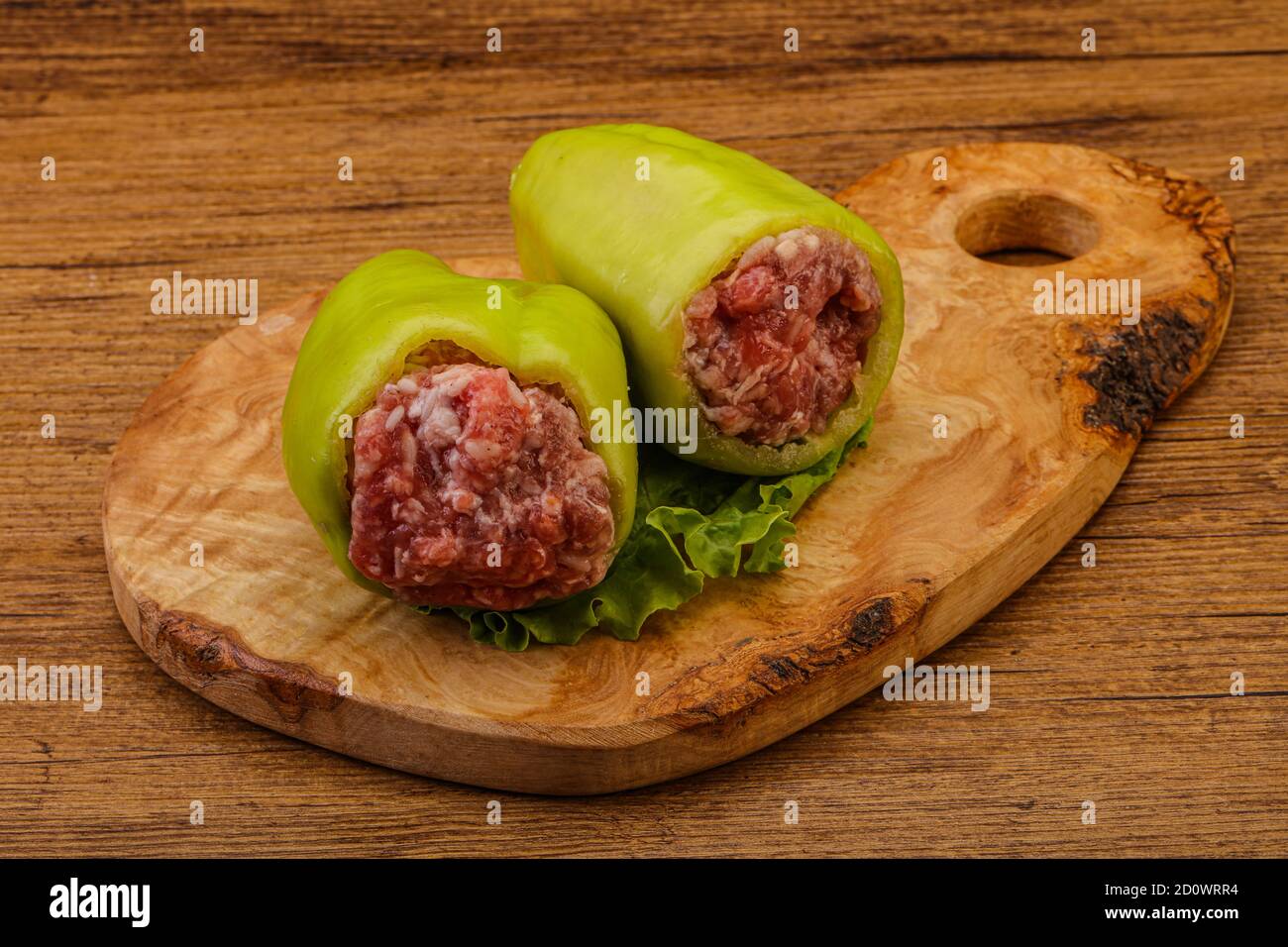 Raw stuffed green bell pepper with meat Stock Photo - Alamy