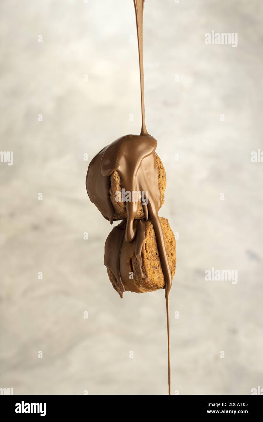 Vertical shot of pieces of cake floating in the air with melted ...
