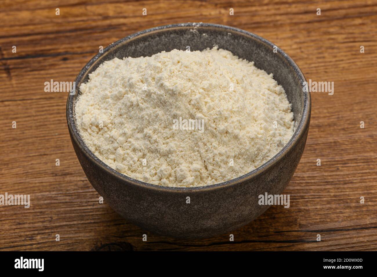 Wheat flour heap in the bowl for cooking Stock Photo - Alamy