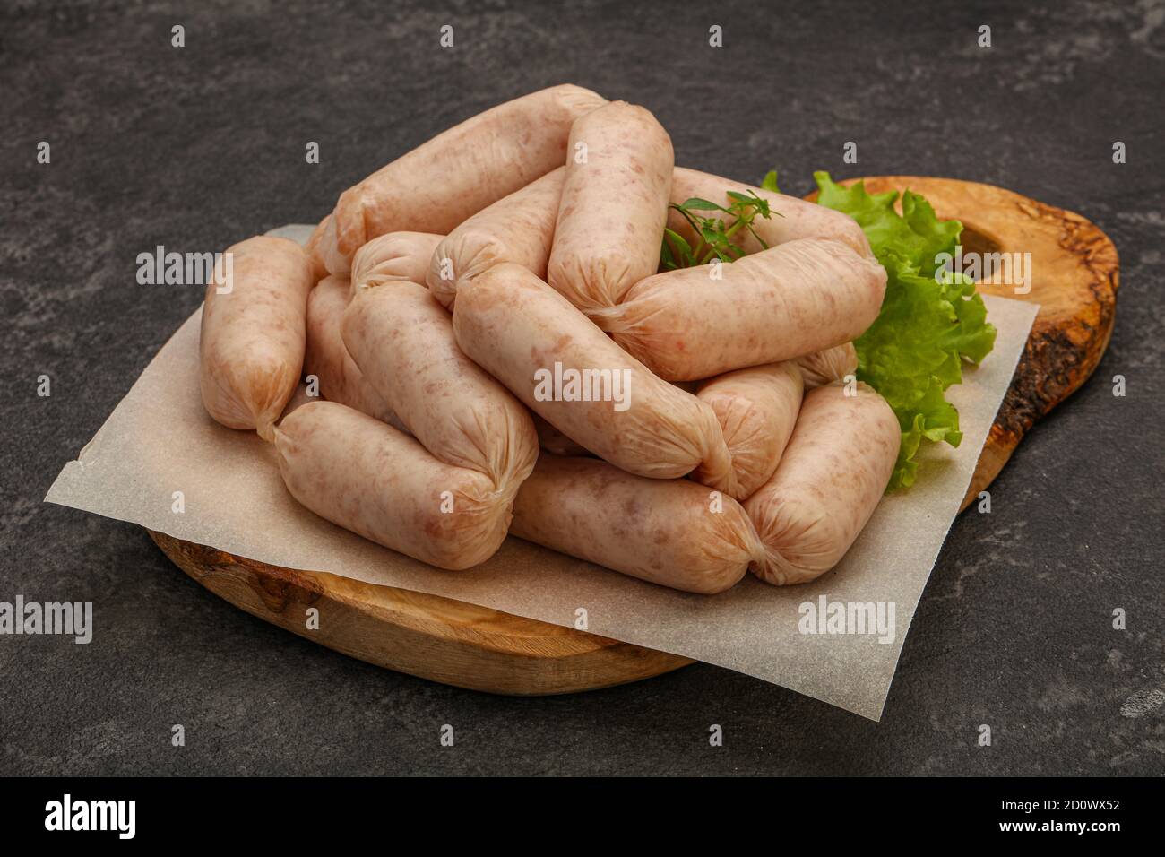 Raw natural chicken baby sausages for roast Stock Photo - Alamy
