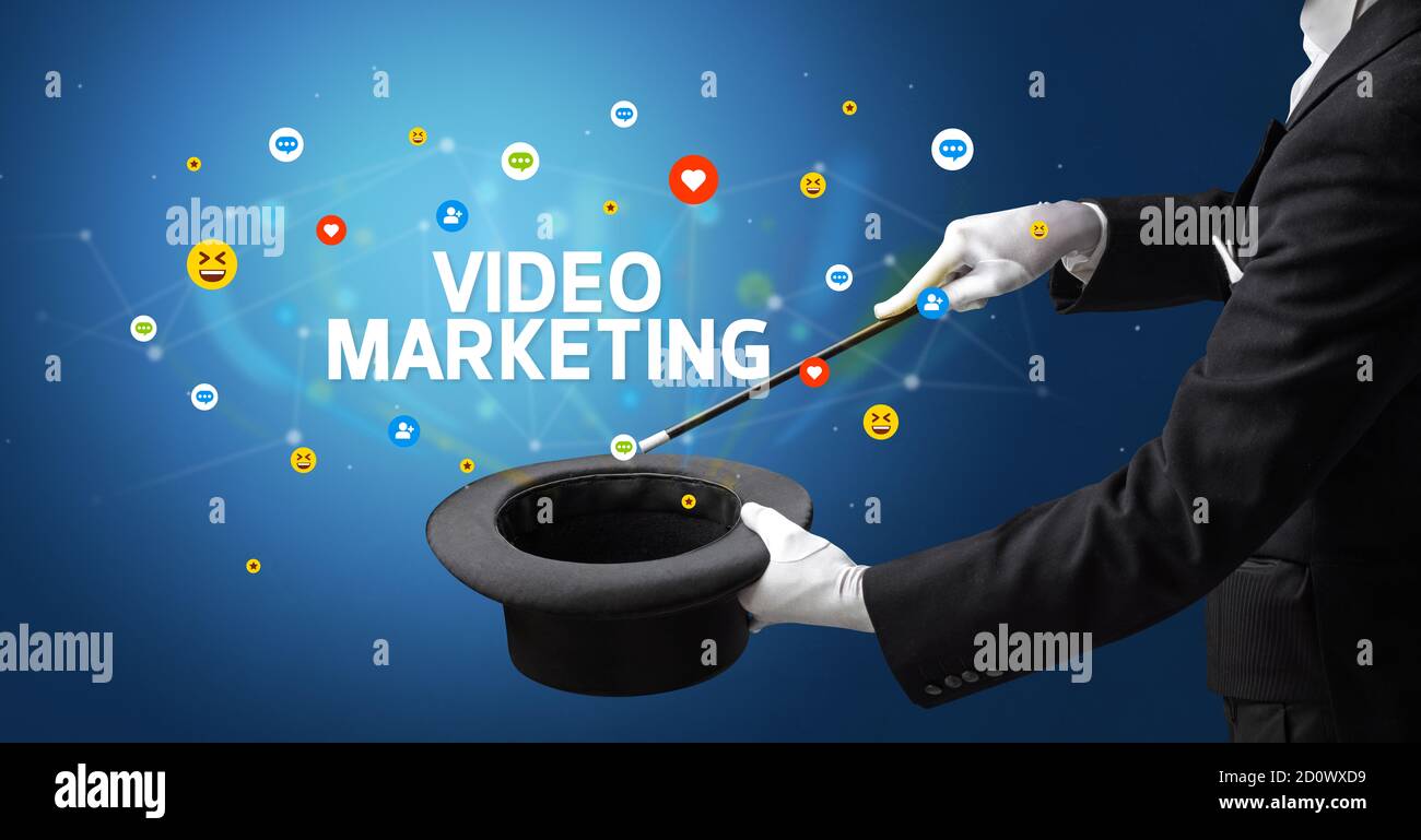 Magician is showing magic trick with VIDEO MARKETING inscription ...