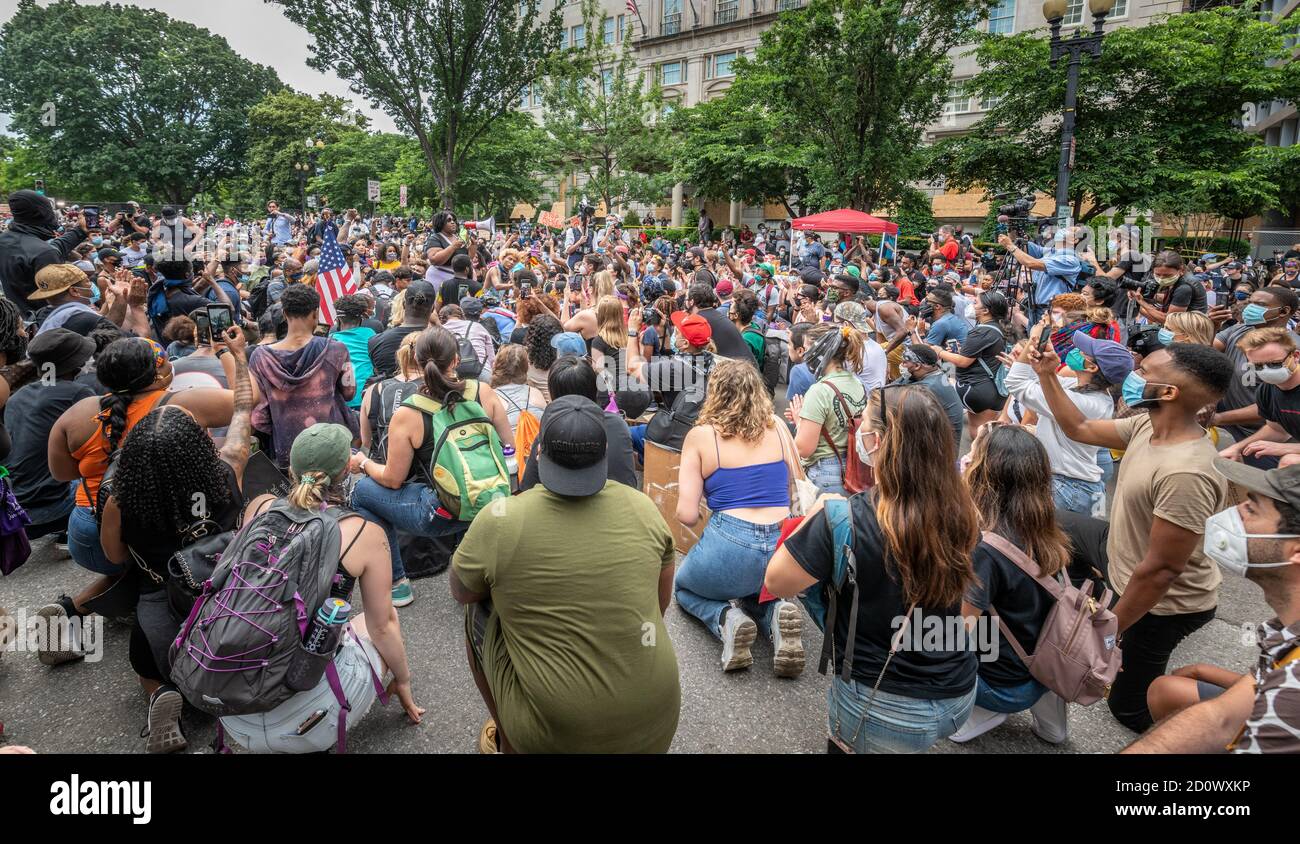 Crowd kneeling together at Black Lives Matter protest in front of white ...