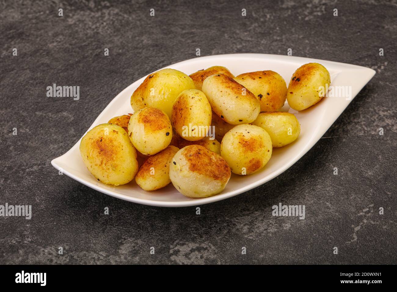 Roasted young baby potato in the bowl Stock Photo - Alamy