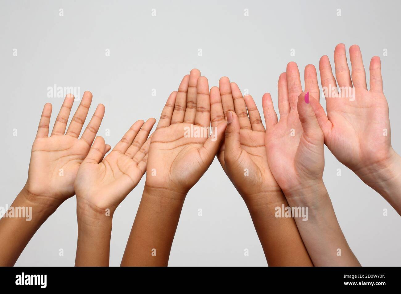 many raised hands in a row Stock Photo - Alamy