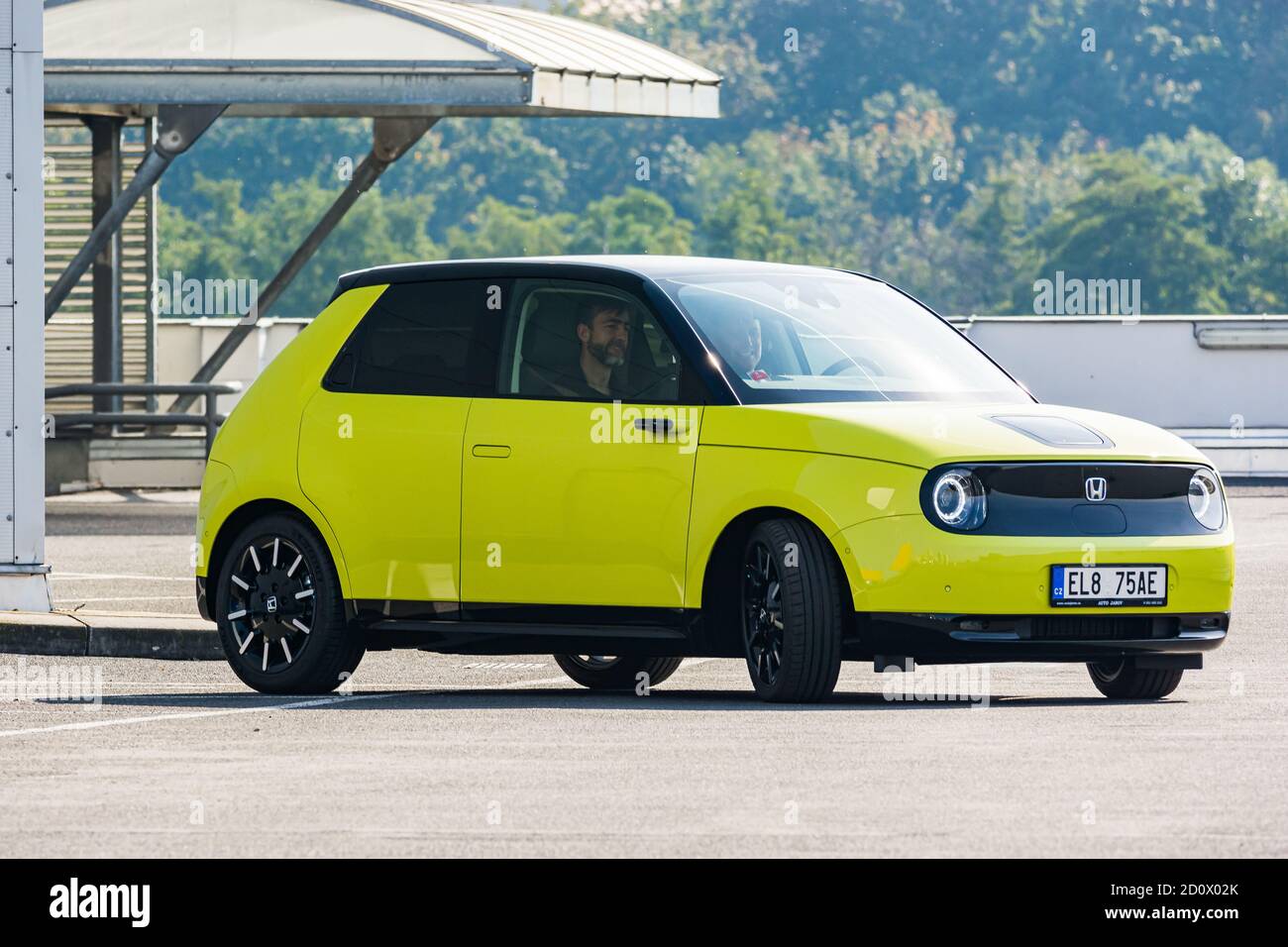 Prague, Czech republic - October 02, 2020. Two men driving in yellow ...