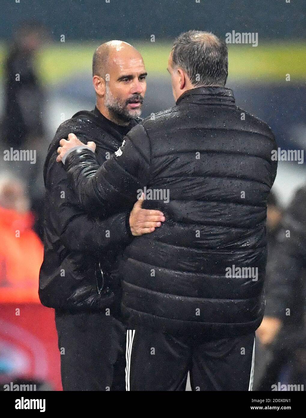 Manchester City manager Pep Guardiola (left) and Leeds United manager ...