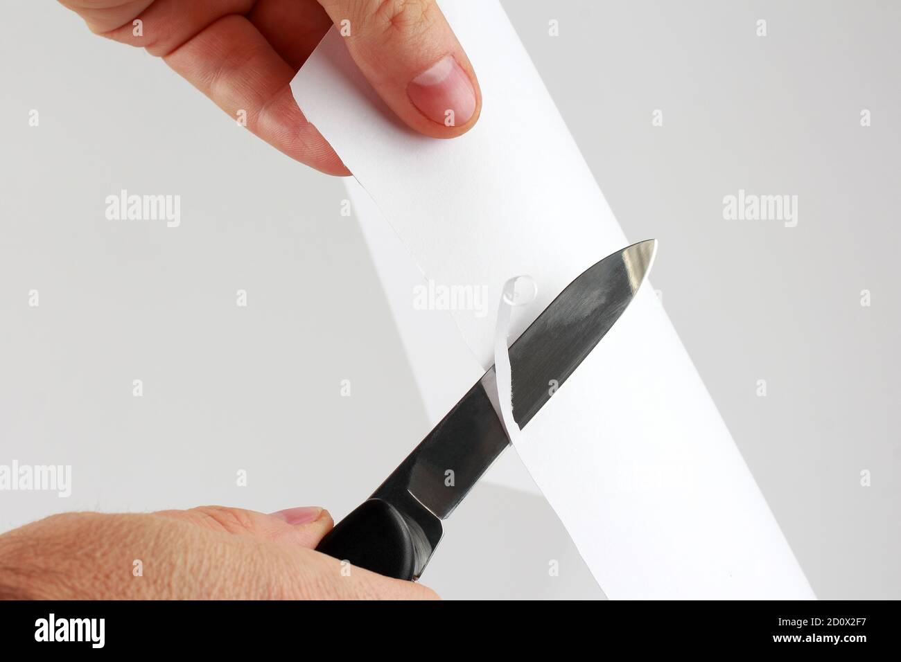 check the sharpening of knife blades on paper Stock Photo - Alamy