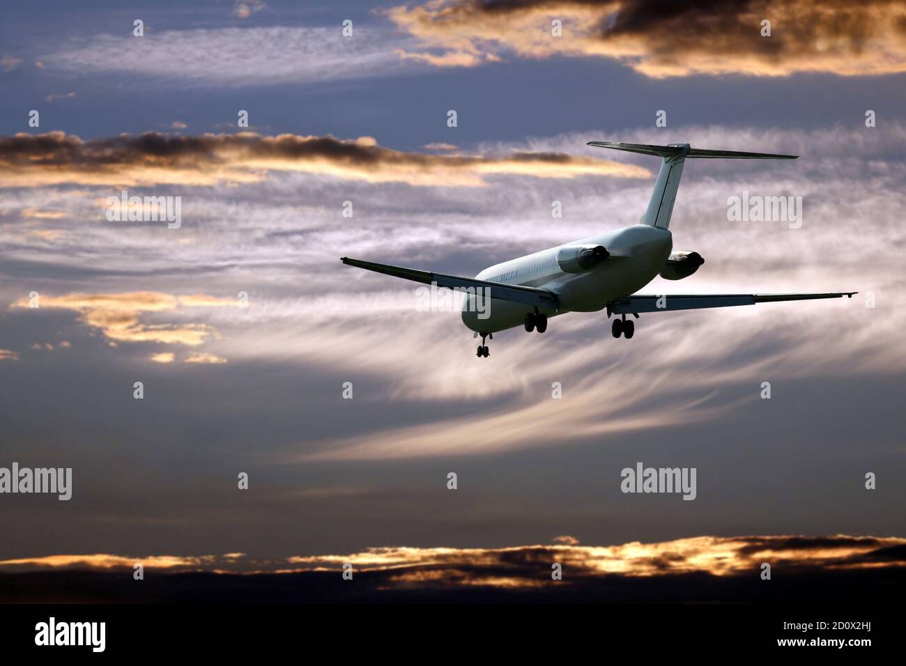 passenger jet plane flying in the evening sky at sunset Stock Photo - Alamy