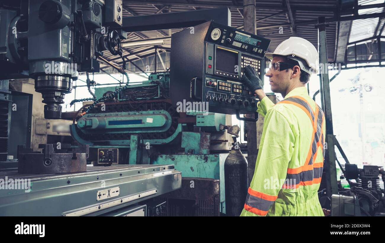Smart factory worker using machine in factory workshop . Industry and ...