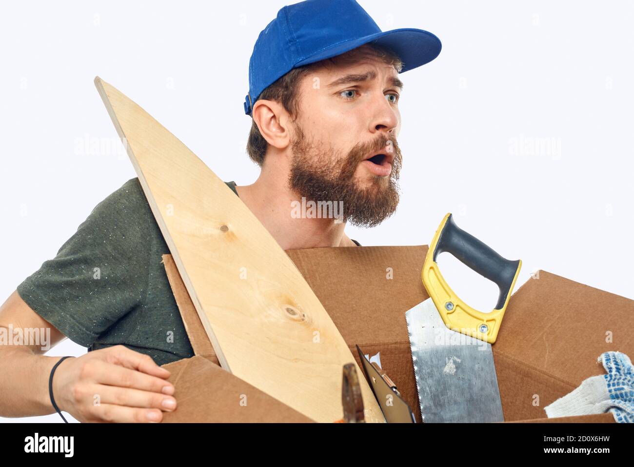 Worker man in uniform with a box in his hands tools delivery service ...