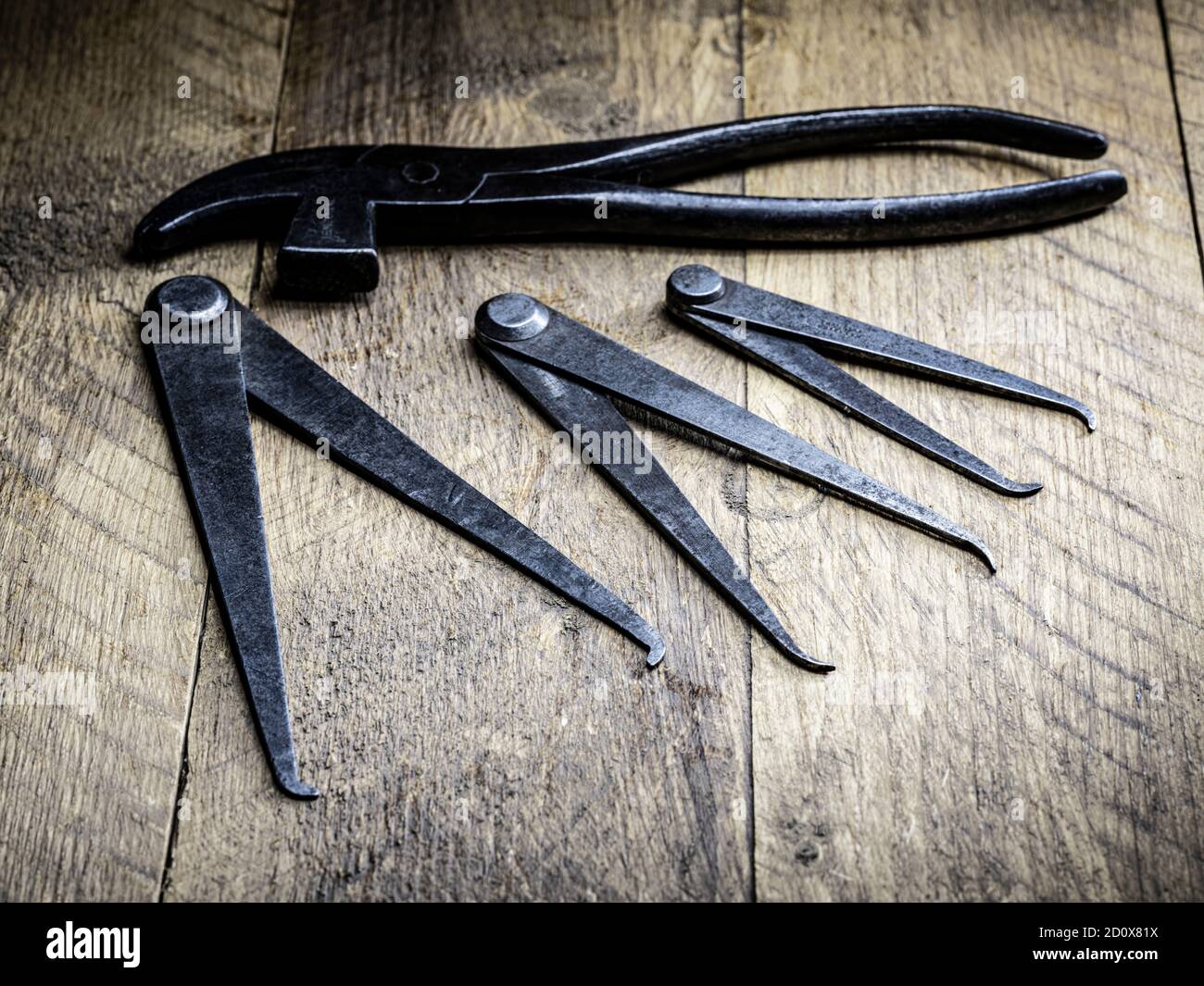 Set of three engineers odd leg callipers on timber flooring resting ...