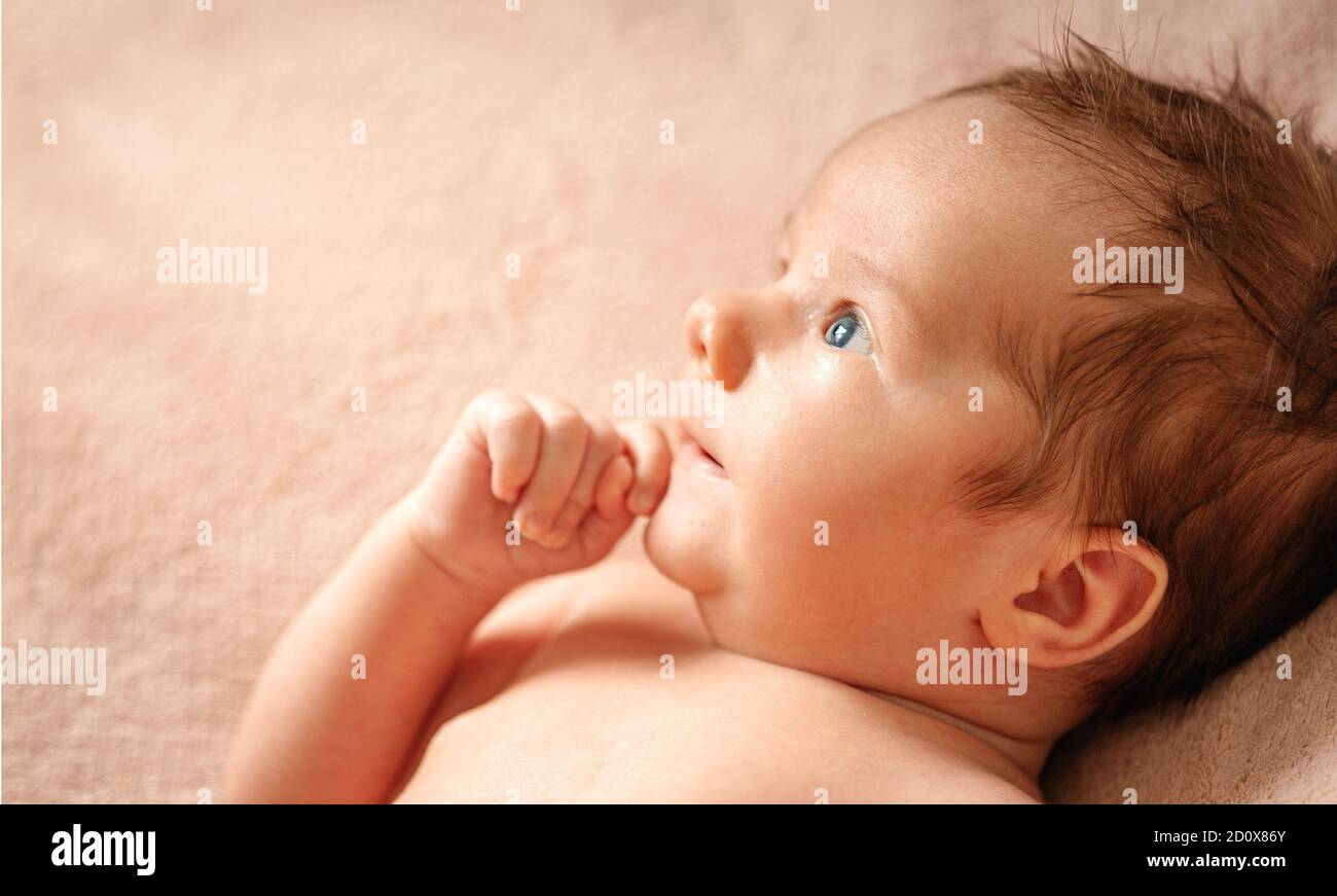 Portrait of a baby boy on a beige background. Selective soft focus ...