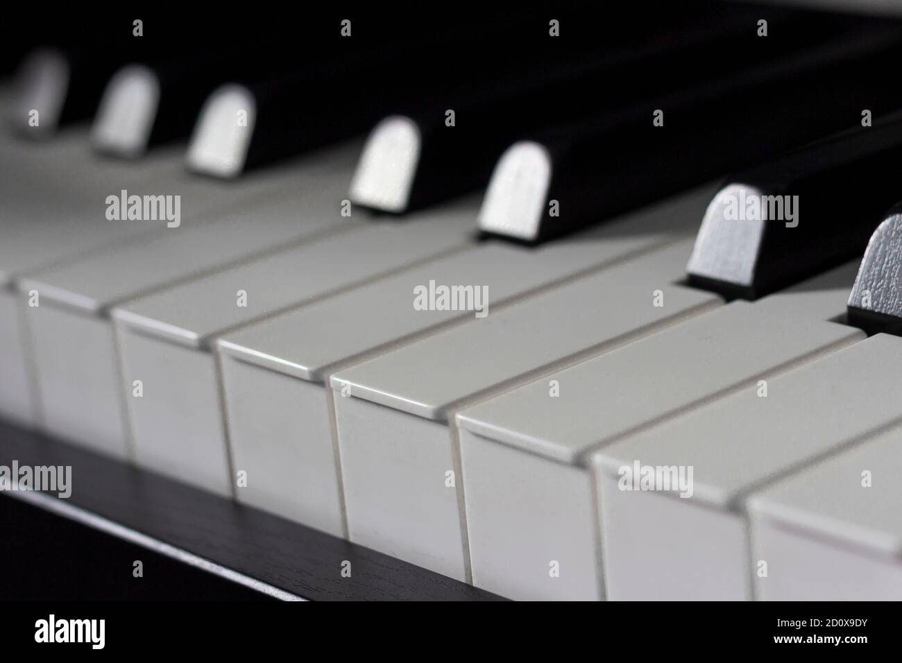 Black and white piano keys in dim lighting and shadows Stock Photo - Alamy