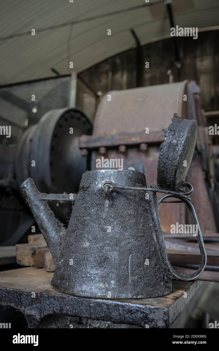 vintage oil container in a workshop Stock Photo - Alamy