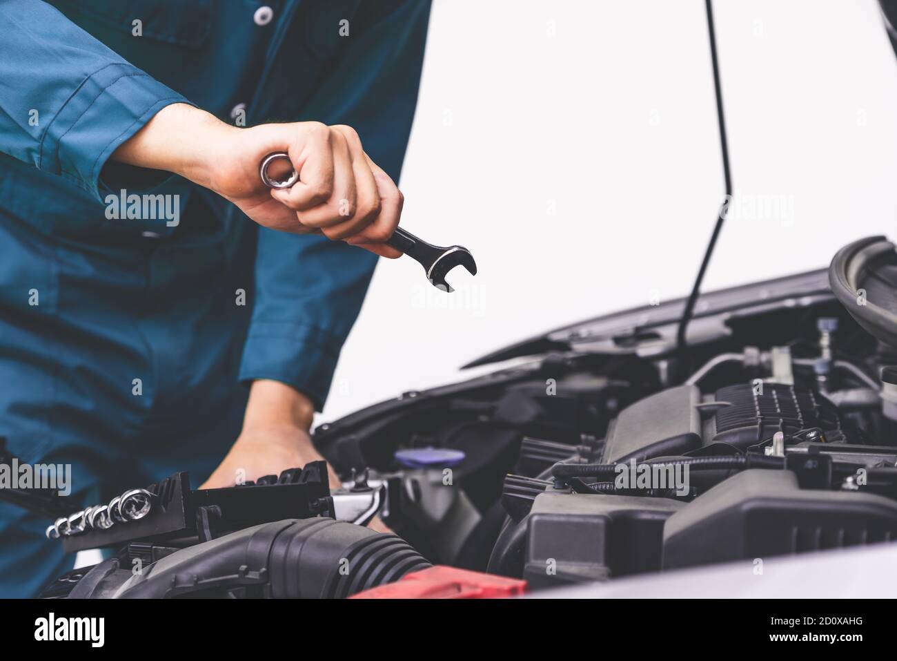 Professional mechanic hand providing car repair and maintenance service ...