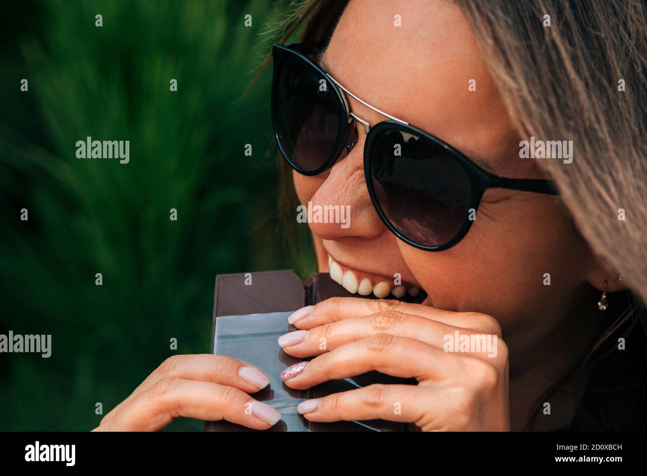 Cute woman tired of dieting stress and very happy to eat chocolate ...