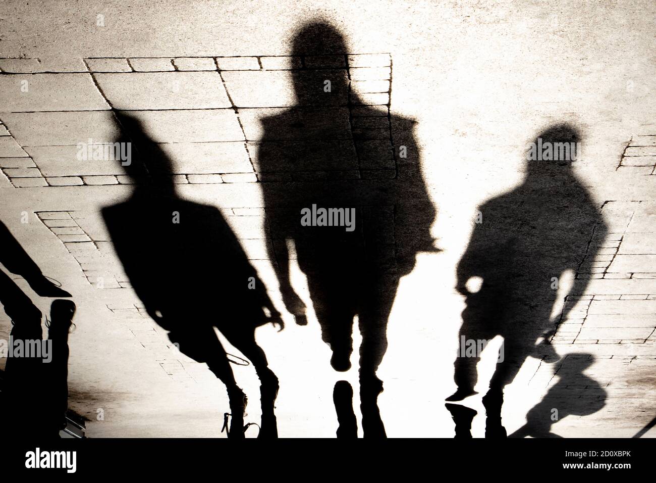 Blurry shadow silhouette of people walking on pedestrian street in high ...