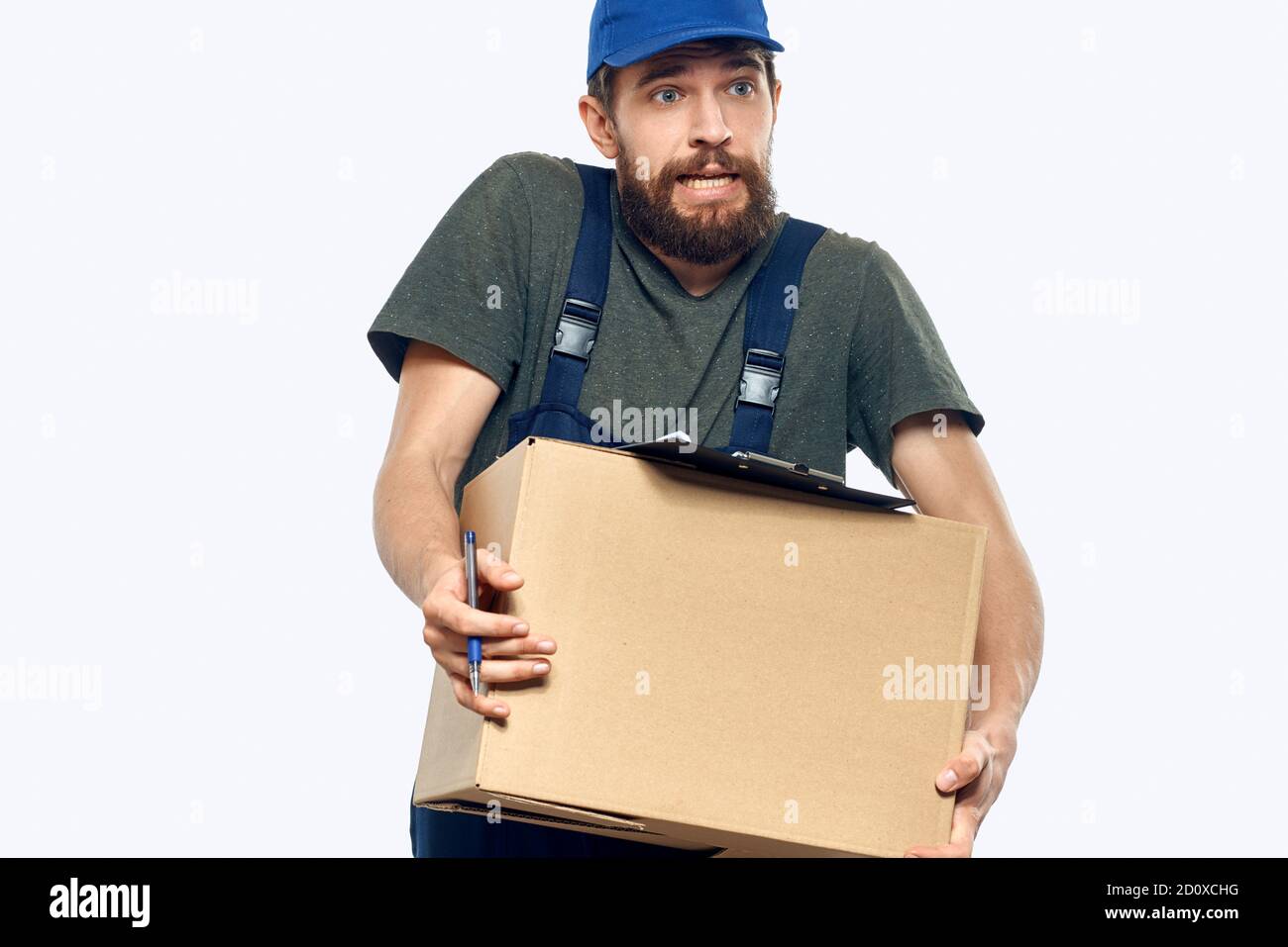 Man in working uniform box delivery loader courier light background ...