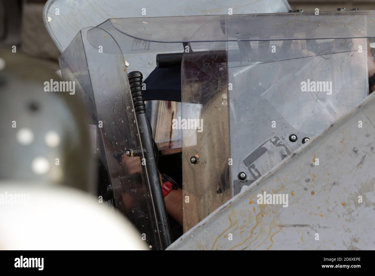 Police officers in protective uniforms from the gendarmery hide behind ...