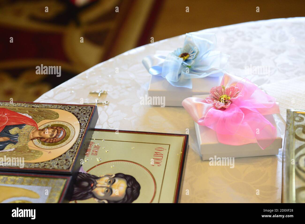 Orthodox baptism - icons and crosses laid on a table for the ceremony ...