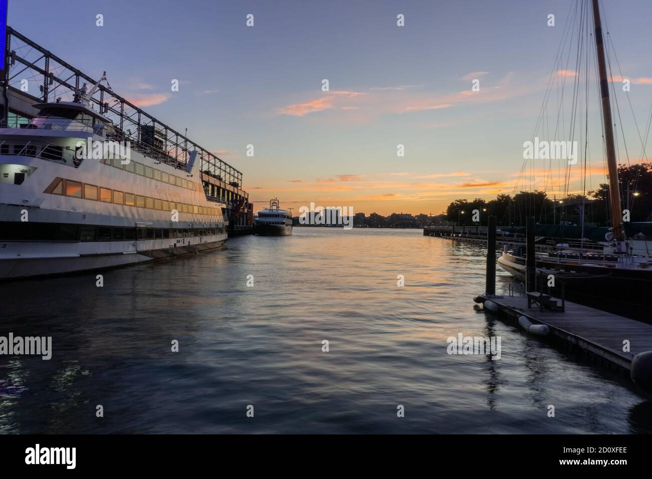 Pier waterfront view to the harbor at sunset. Boats docked at Chelsea ...