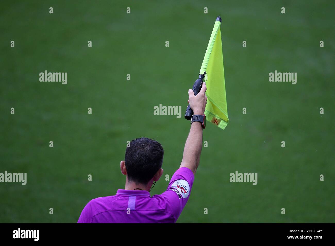 The assistant referee raises flag for offside hi-res stock photography ...