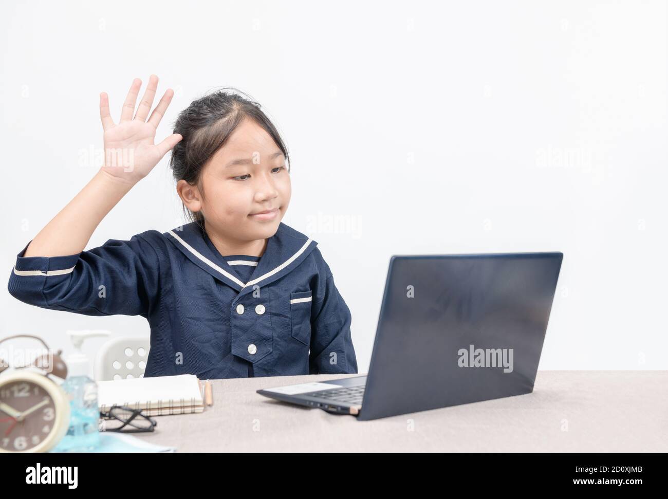 Asian girl making facetime video calling with laptop at home on white ...