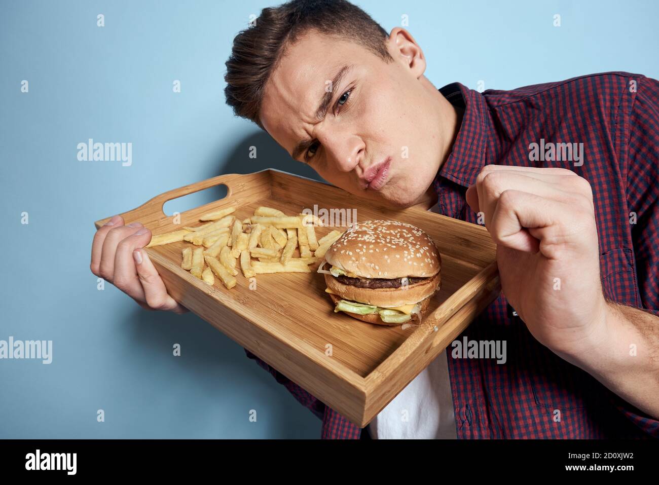 Man with wooden pallet fast food french fries hamburger hunger diet ...