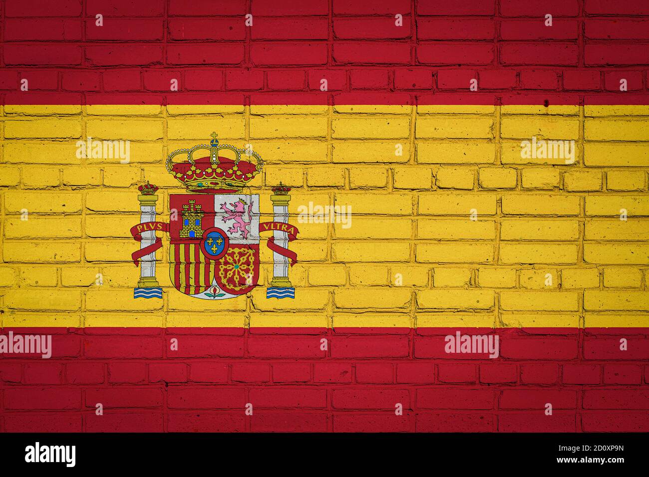 National flag of Spain depicting in paint colors on an old brick wall ...
