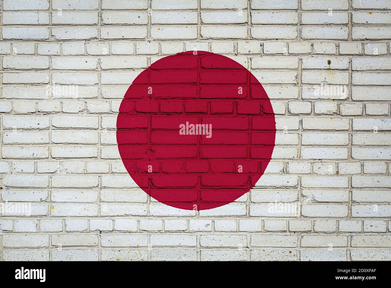 National flag of Japan depicting in paint colors on an old brick wall ...