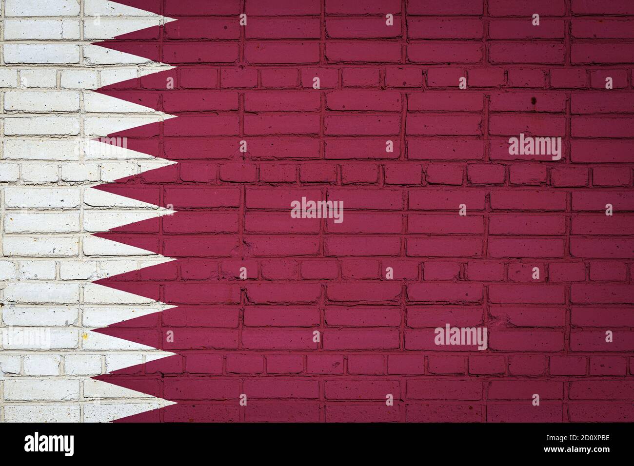 National flag of Qatar depicting in paint colors on an old brick wall ...