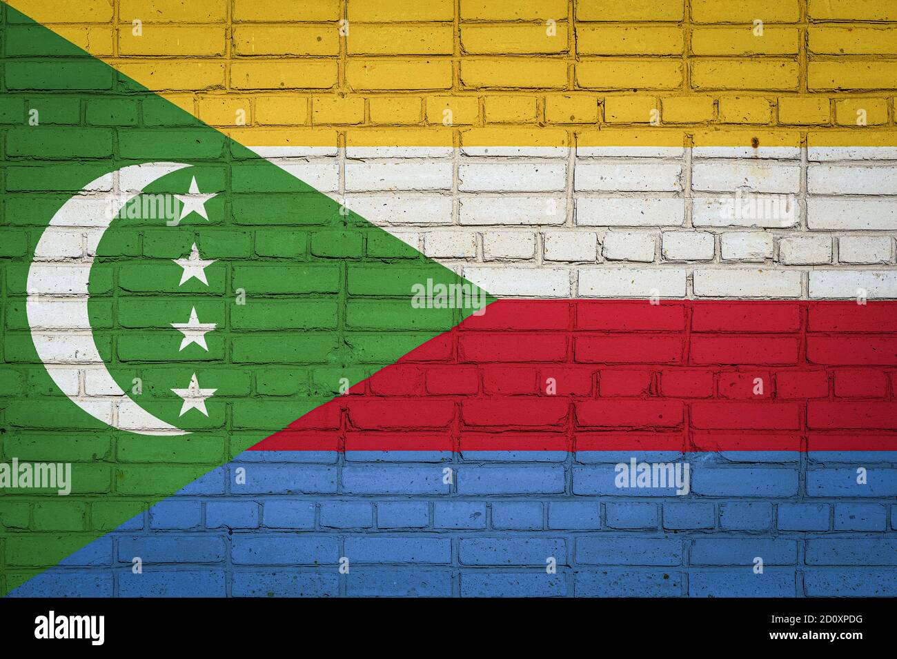 National flag of Comoros depicting in paint colors on an old brick wall ...