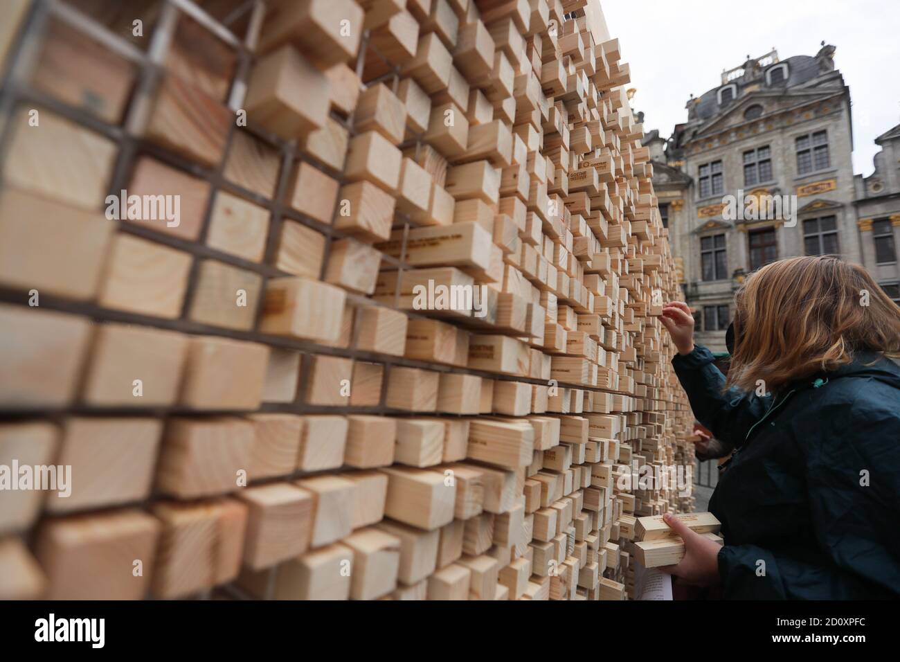 Brussels, Belgium. 3rd Oct, 2020. A woman takes wooden blocks from "the ...