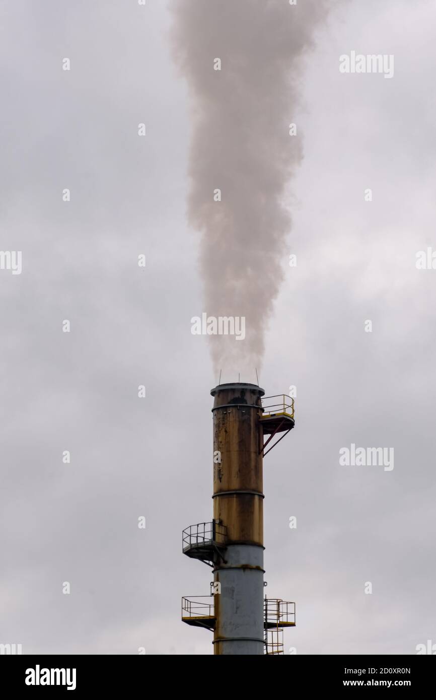 An industrial smoke stack emits pollution into the atmosphere Stock ...