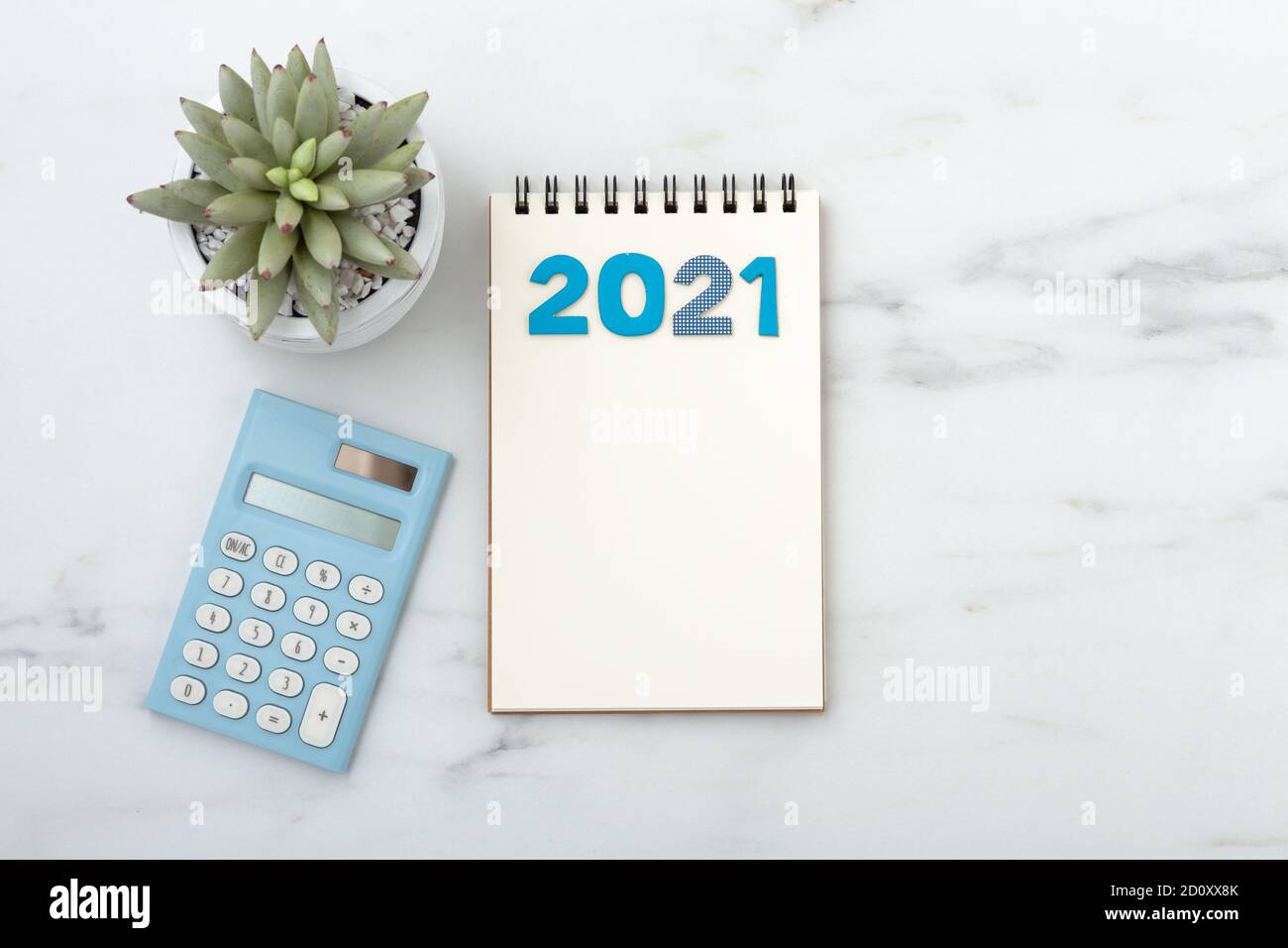2021 on notebook with calculator on desk, top view with copy space ...
