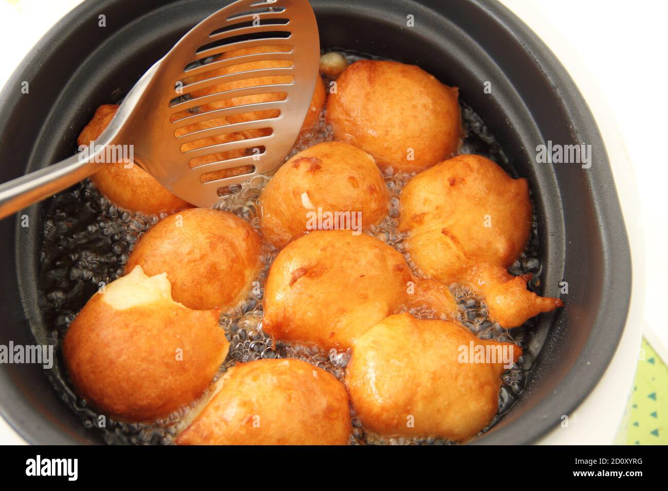 fresh donuts deep-fried in the deep fryer Stock Photo - Alamy