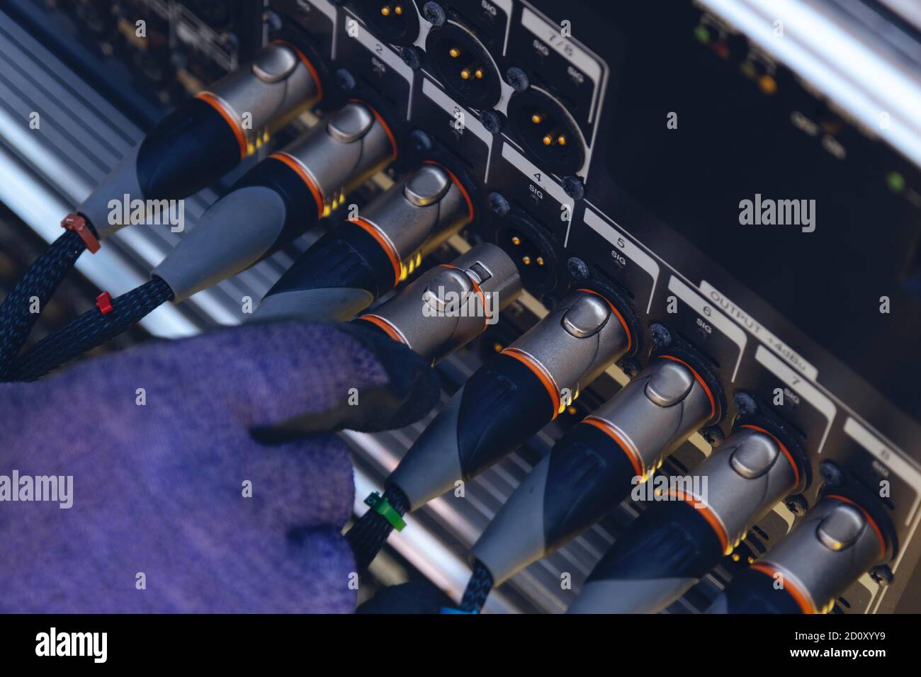 Sound engineer plugging audio cable on studio system boxes Stock Photo ...