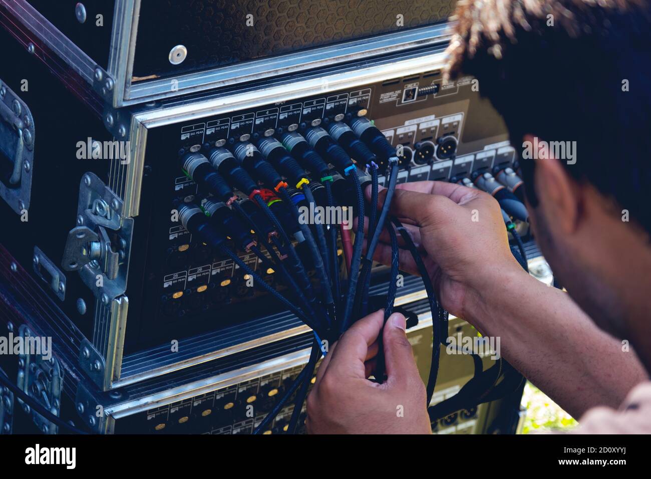 Sound engineer plugging audio cable on studio system boxes Stock Photo ...