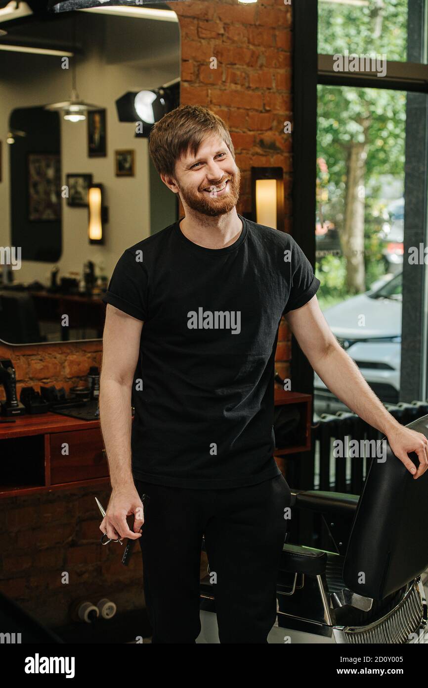 Portrait of a charming male hairdresser in a barber shop Stock Photo ...