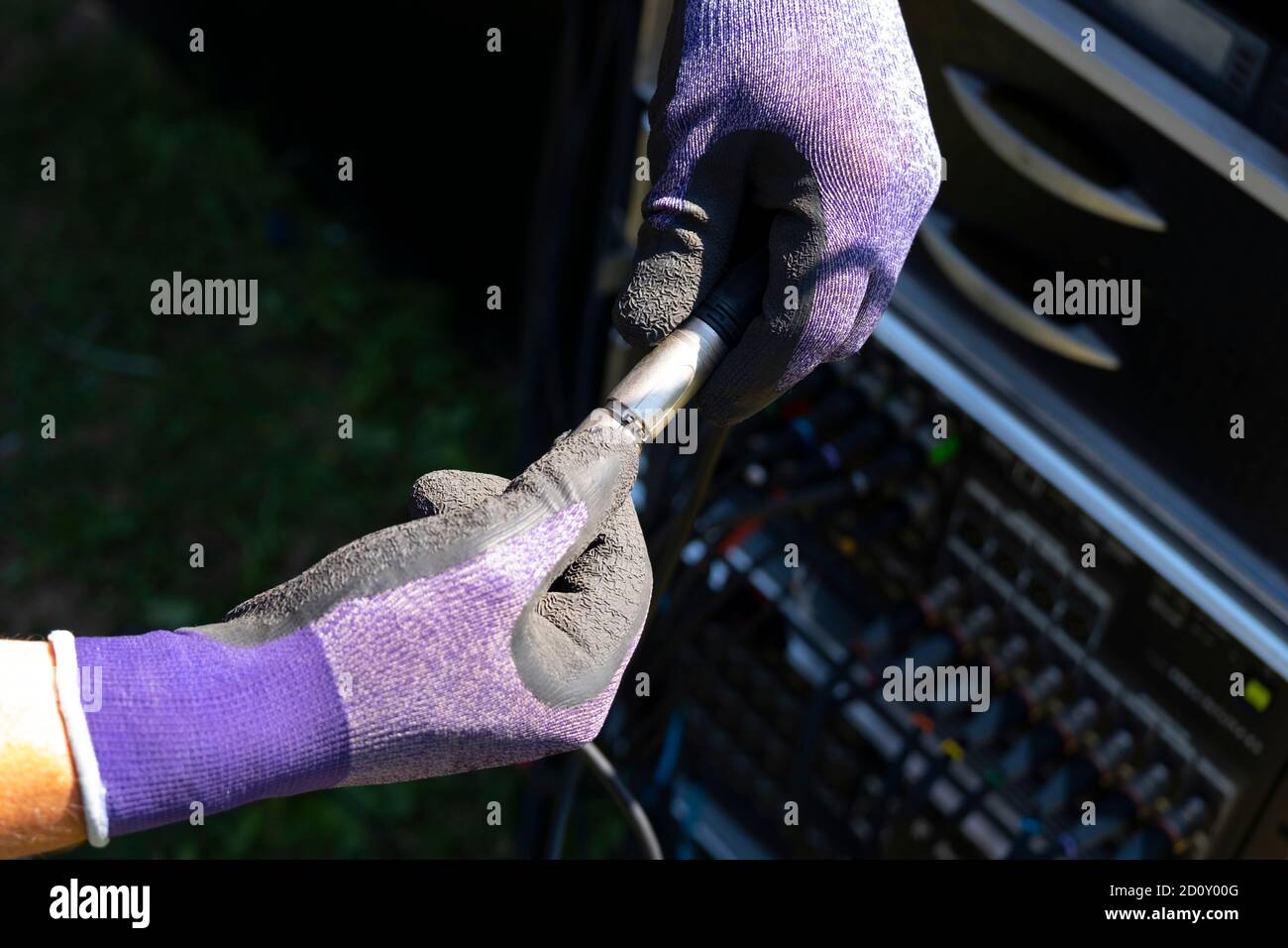 In preparation for a concert, the sound engineer is connecting the ...