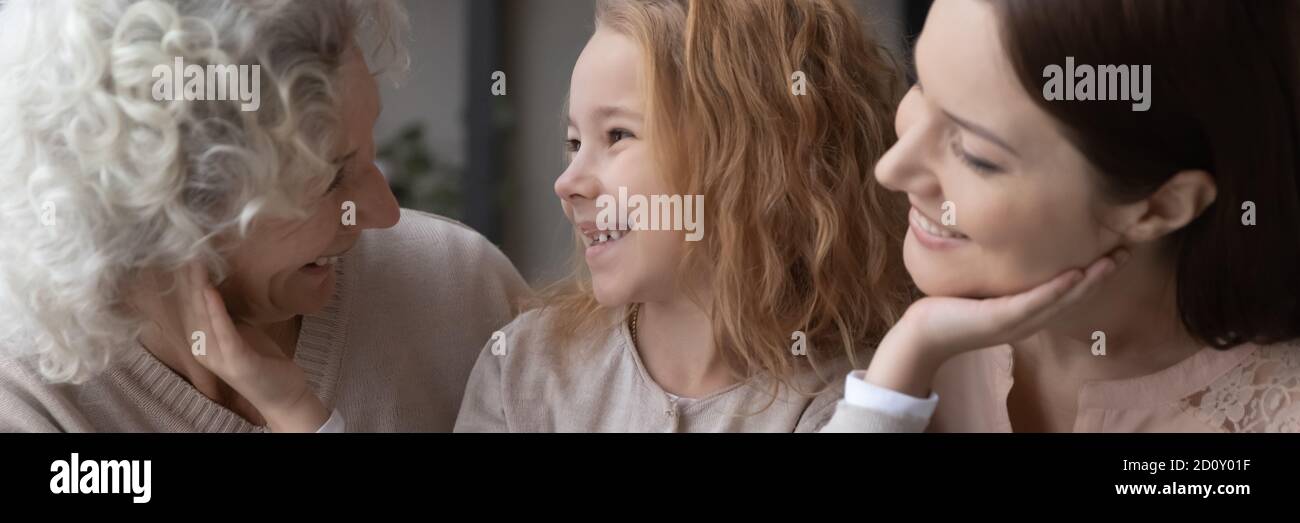 Wide image three generations of women enjoying tender moment Stock ...