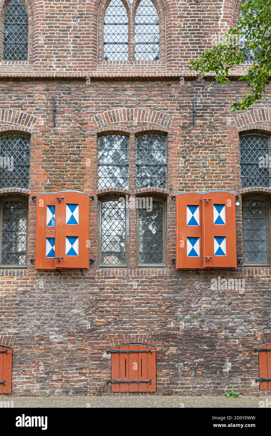 Historic Dutch castle wall with windows with stained glass and ...
