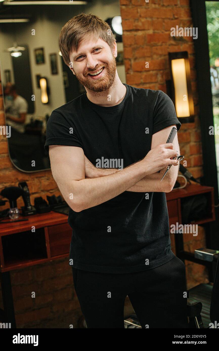 Happy good looking male hairdresser in a barber shop Stock Photo - Alamy