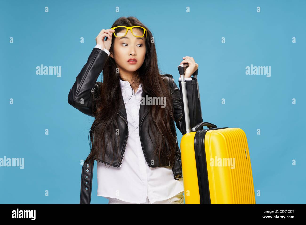 Surprised woman hurries on a flight with a suitcase Stock Photo - Alamy